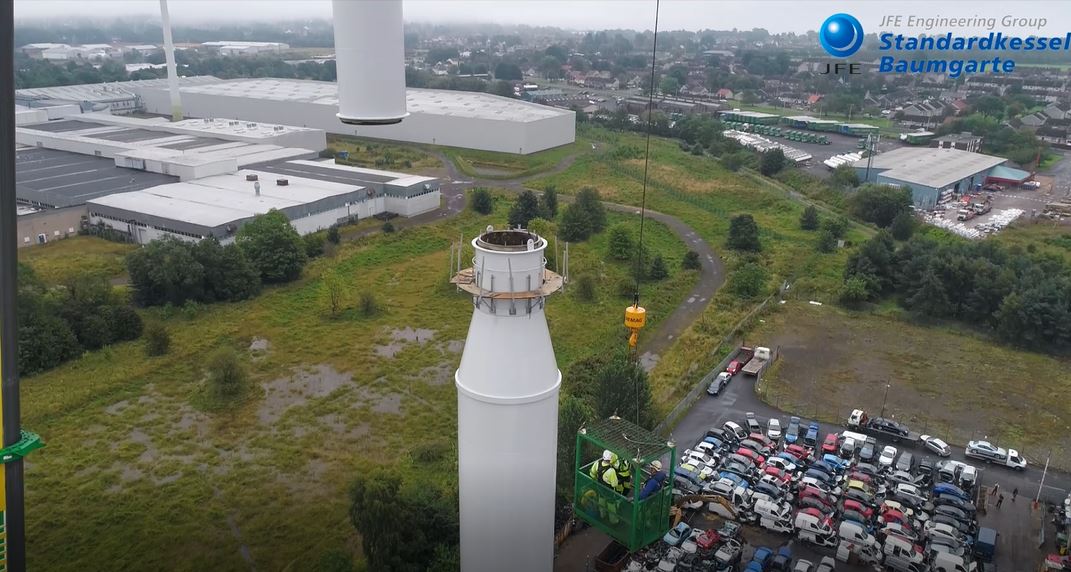 VIDEO: Incredible footage shows brave workers installing huge chimney ...