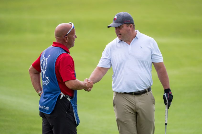 Graham Low switches his St Andrews Links caddie's bib for PPE on the ...