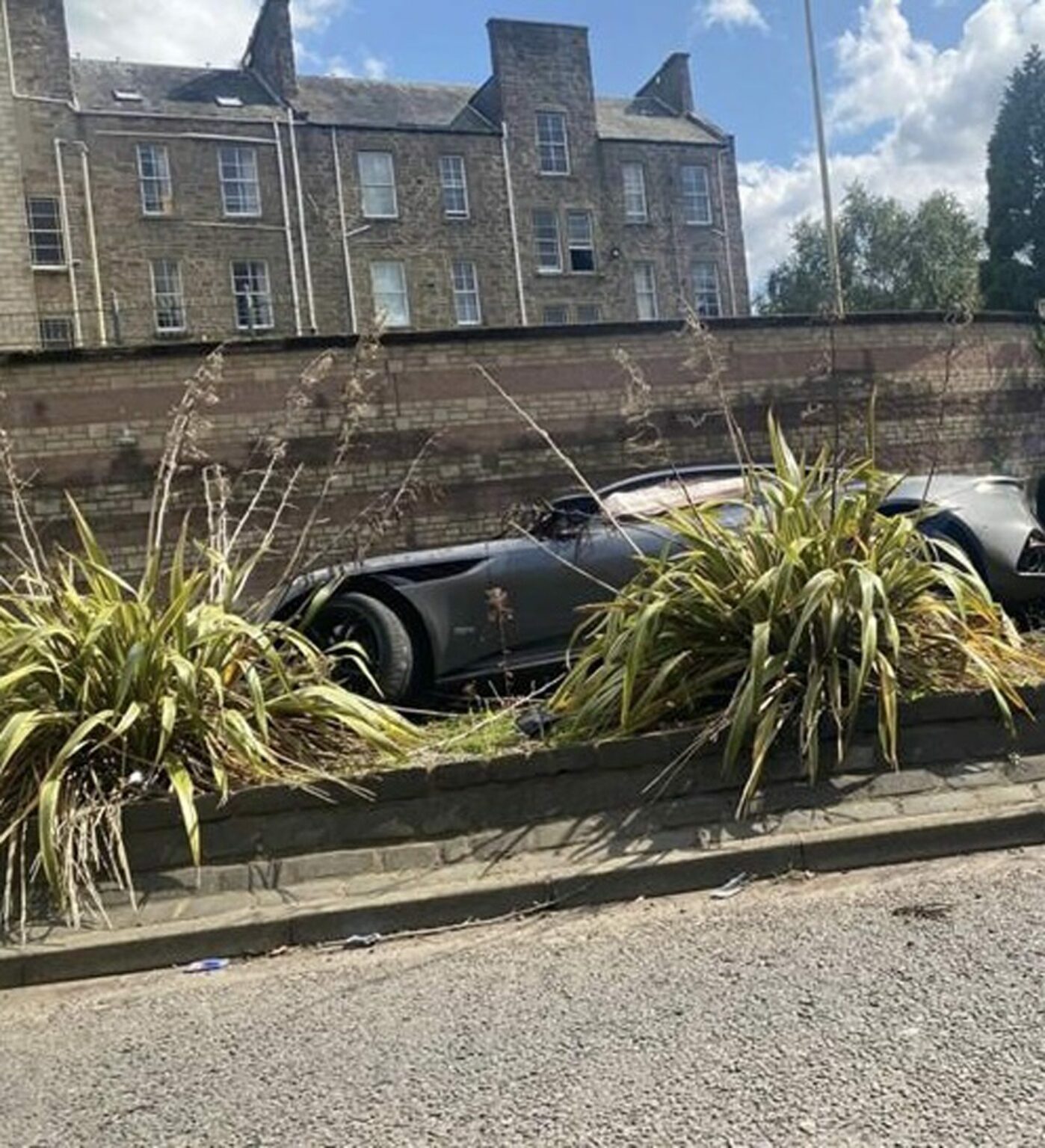 Aston Martin crashes into central reservation at Dundee roundabout