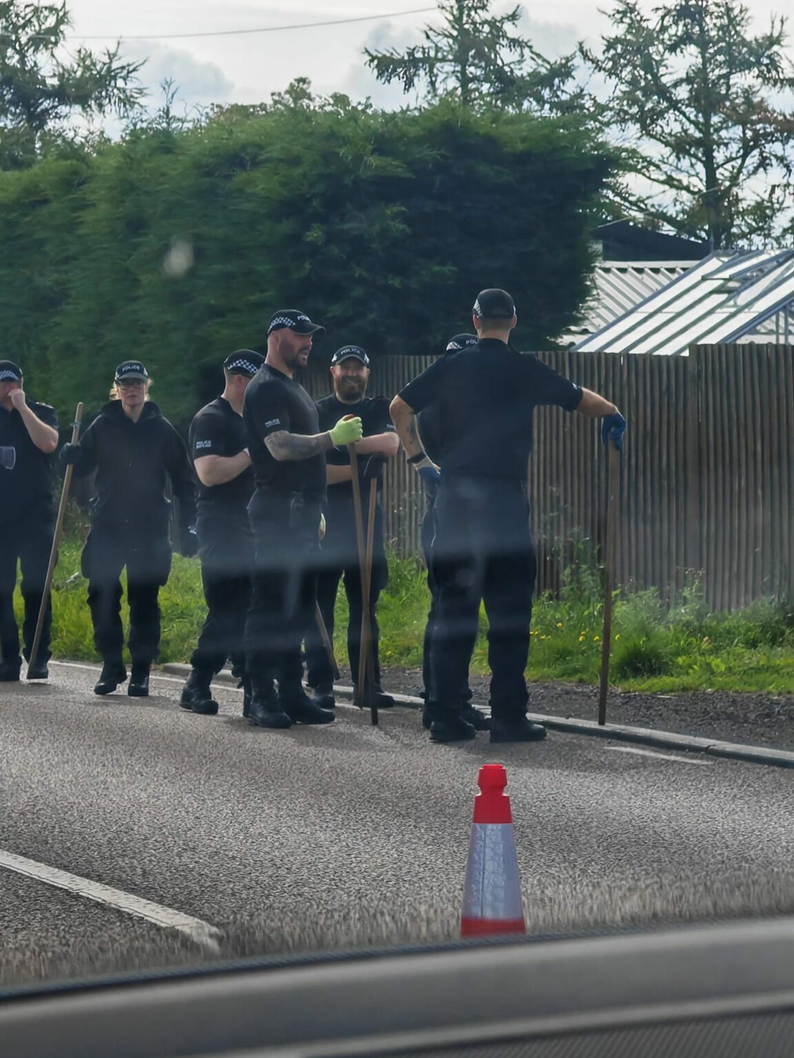 Police seen searching field along busy St Andrews to Dundee road