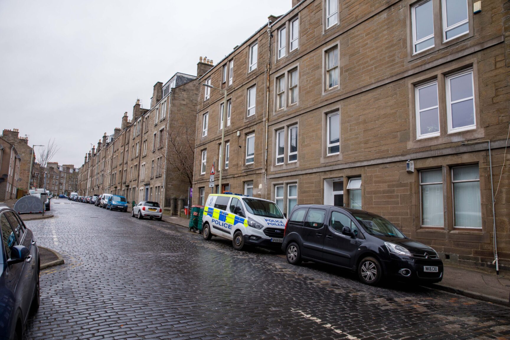 Police in Dundee street as man remains in hospital after flat fall
