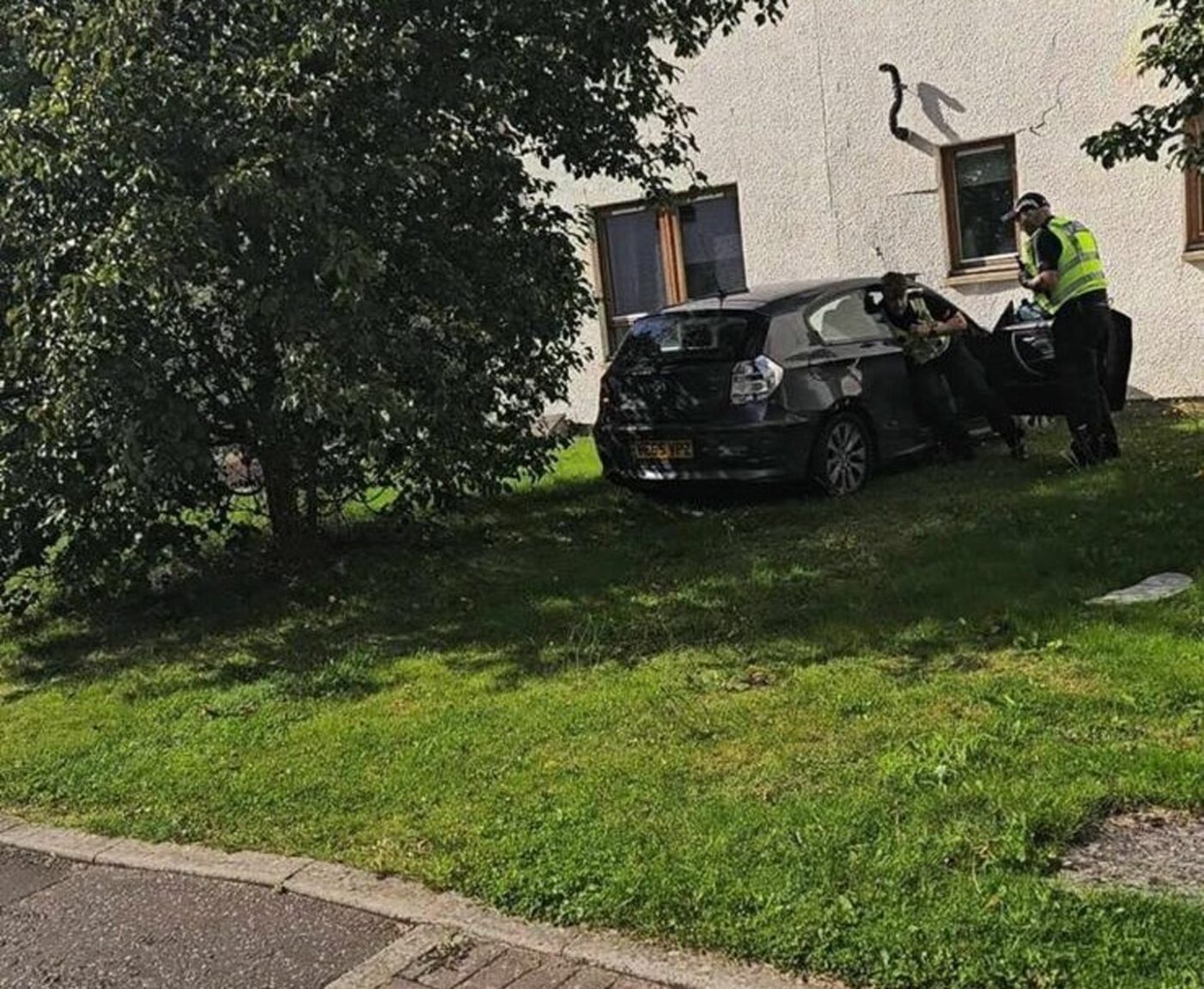 Driver smashed BMW into Fife house and dragged police officer