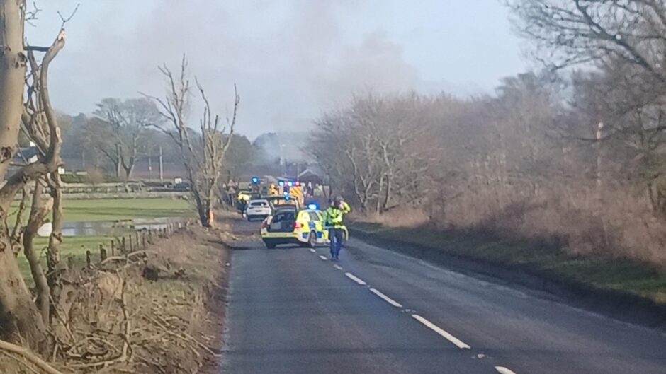 Five in hospital after crash and car fire close main road in Angus