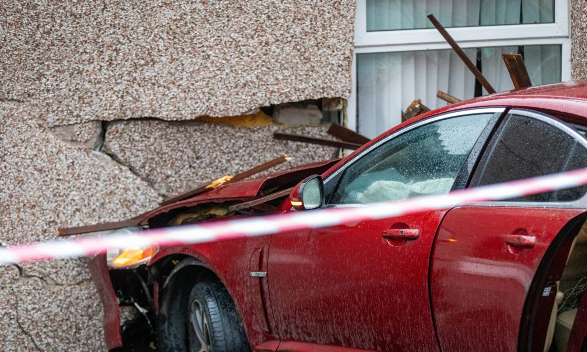 Driver charged after vehicle crashes into house on Dundee street
