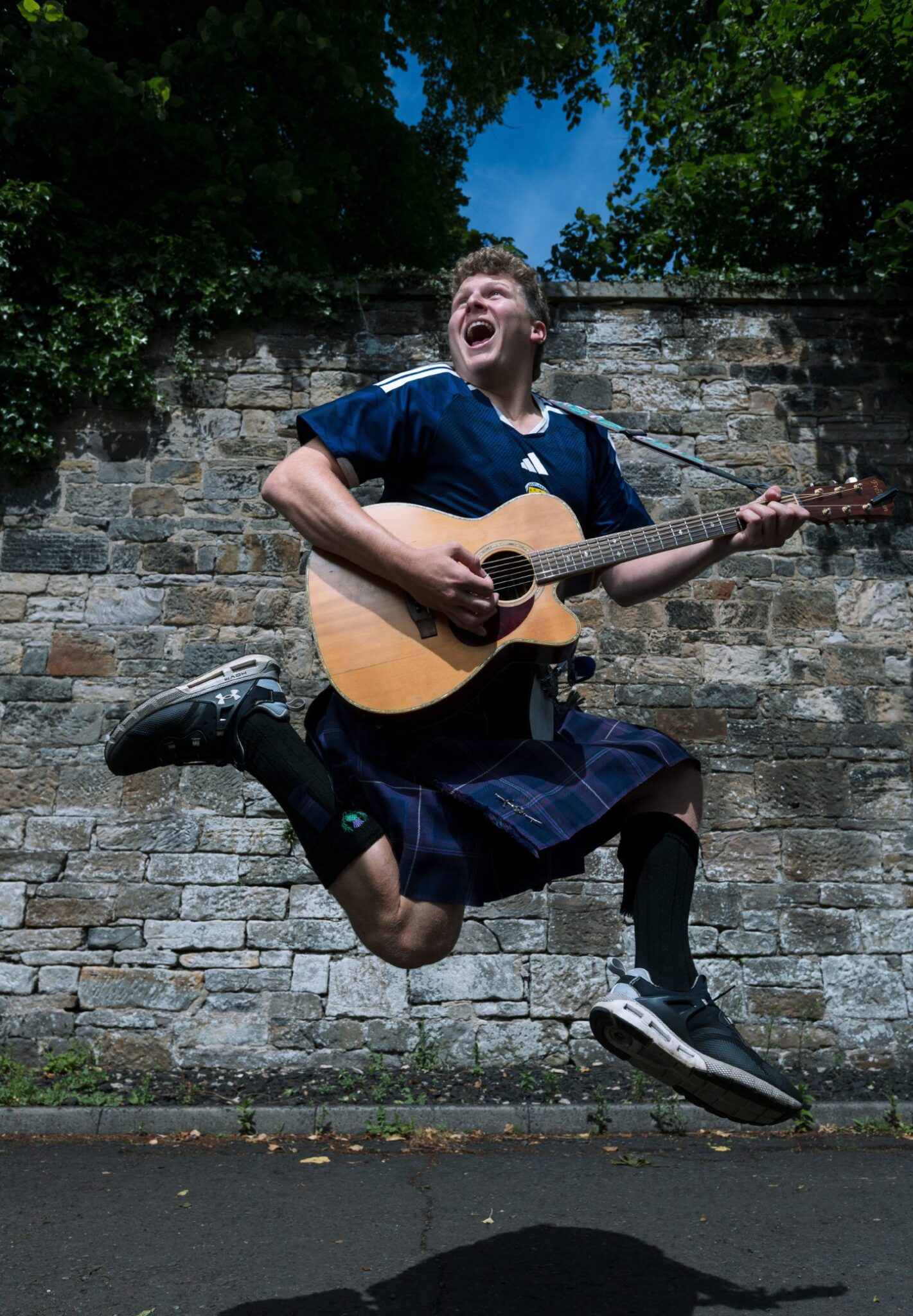 Busker raises cash for World Cup trip by singing to Tartan Army