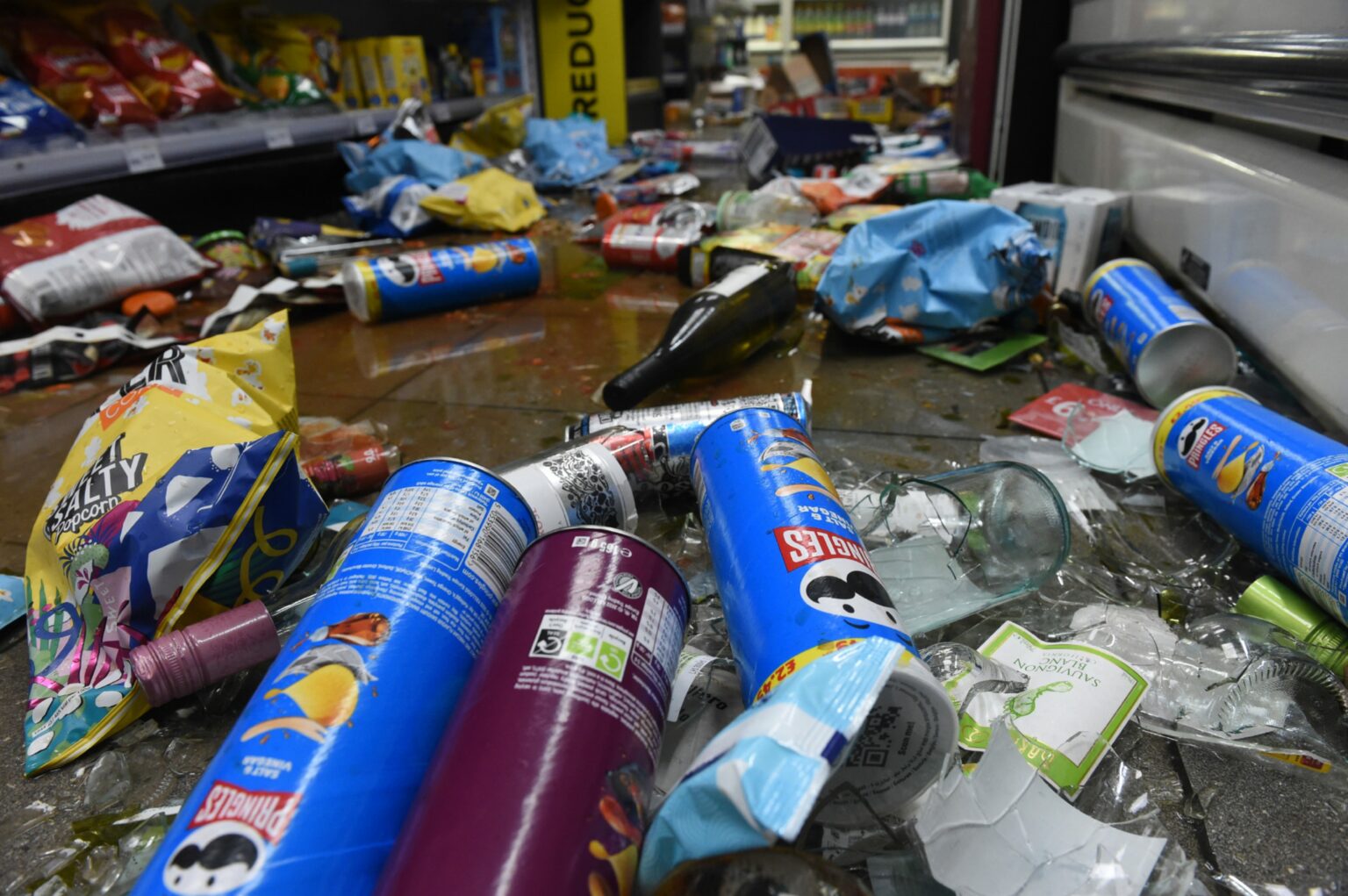 Pictures show smashed windows and broken bottles strewn across floor ...