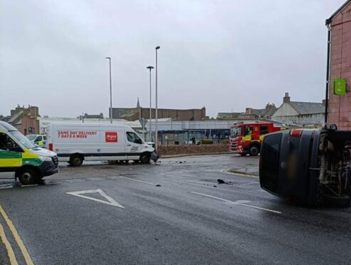 Car lands on side following two-vehicle crash on Peterhead street ...