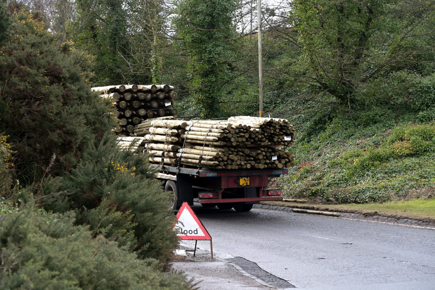 Lorry sheds its load of logs at Raigmore Interchange in Inverness