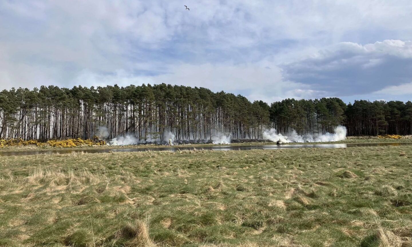 Fire crews battle wildfire on the banks of the River Lossie