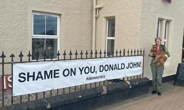 Banner protesting Donald Trump returns to Stornoway shop