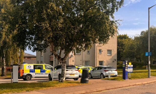 Police descend on Elgin block of flats after missing person report